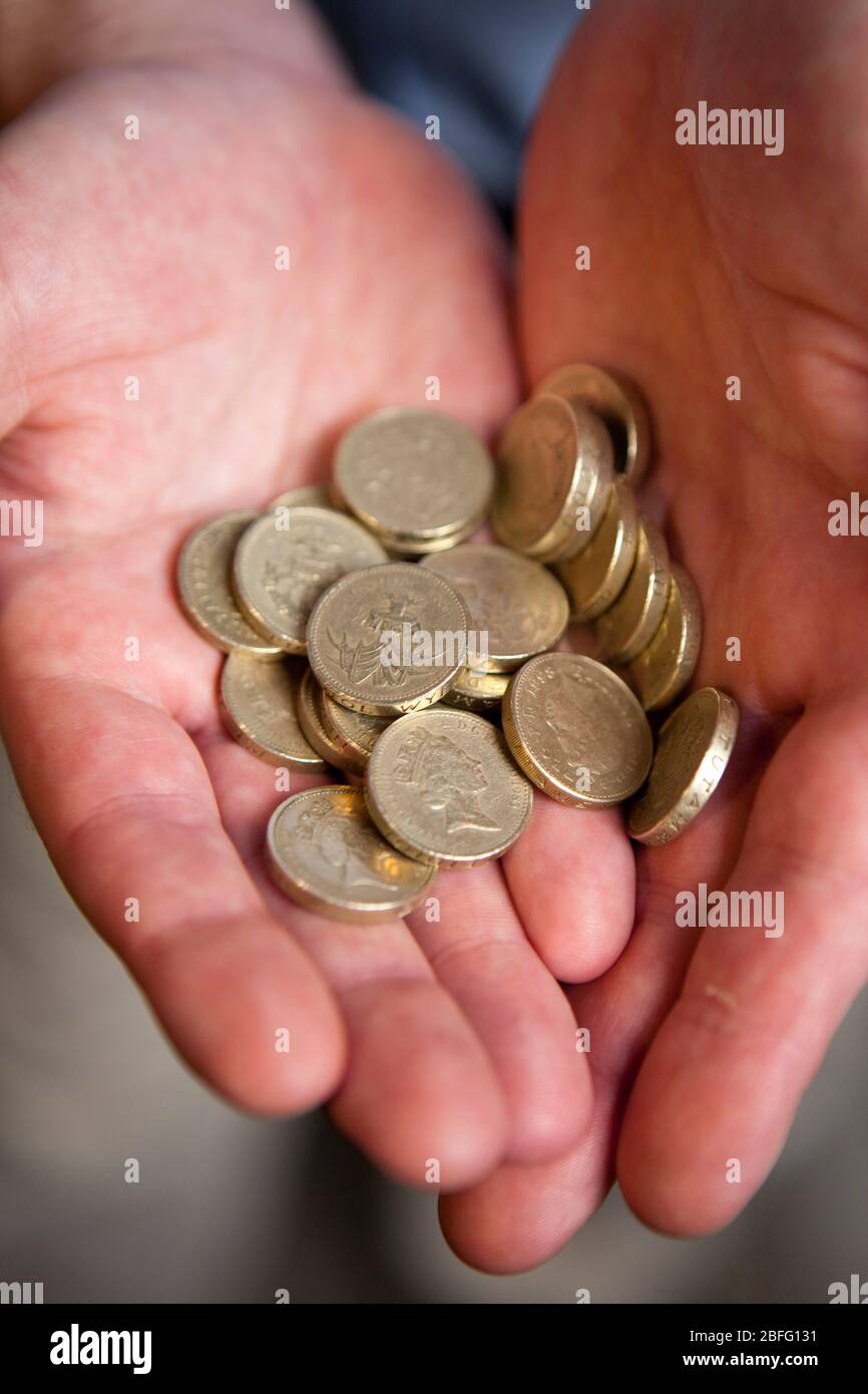 A handful of £1 coins Stock Photo - Alamy