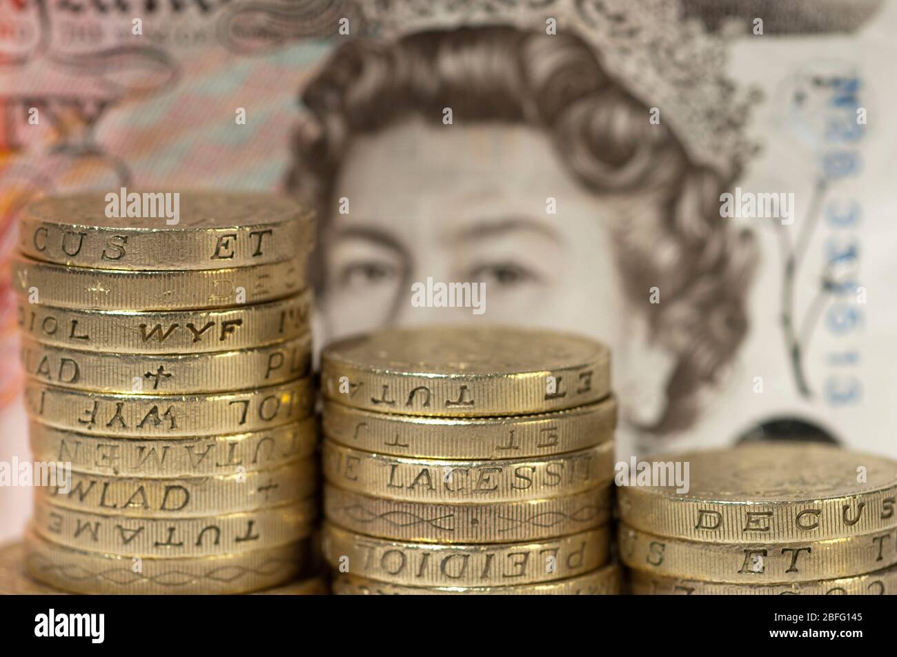 Illustrative image of a £50 note and stacks of pound coins Stock Photo ...