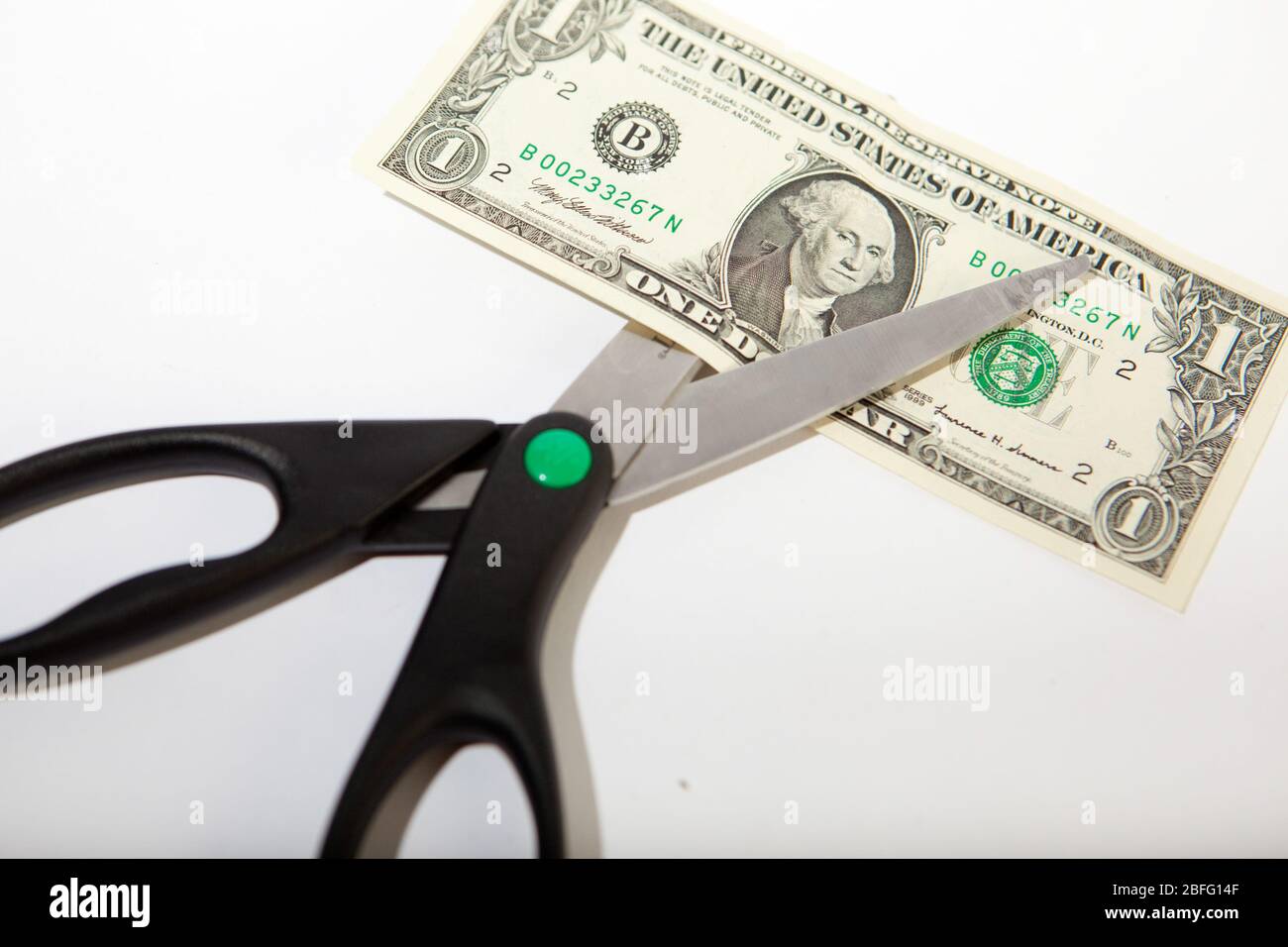 Figurative image of a one dollar bill being cut in half Stock Photo - Alamy