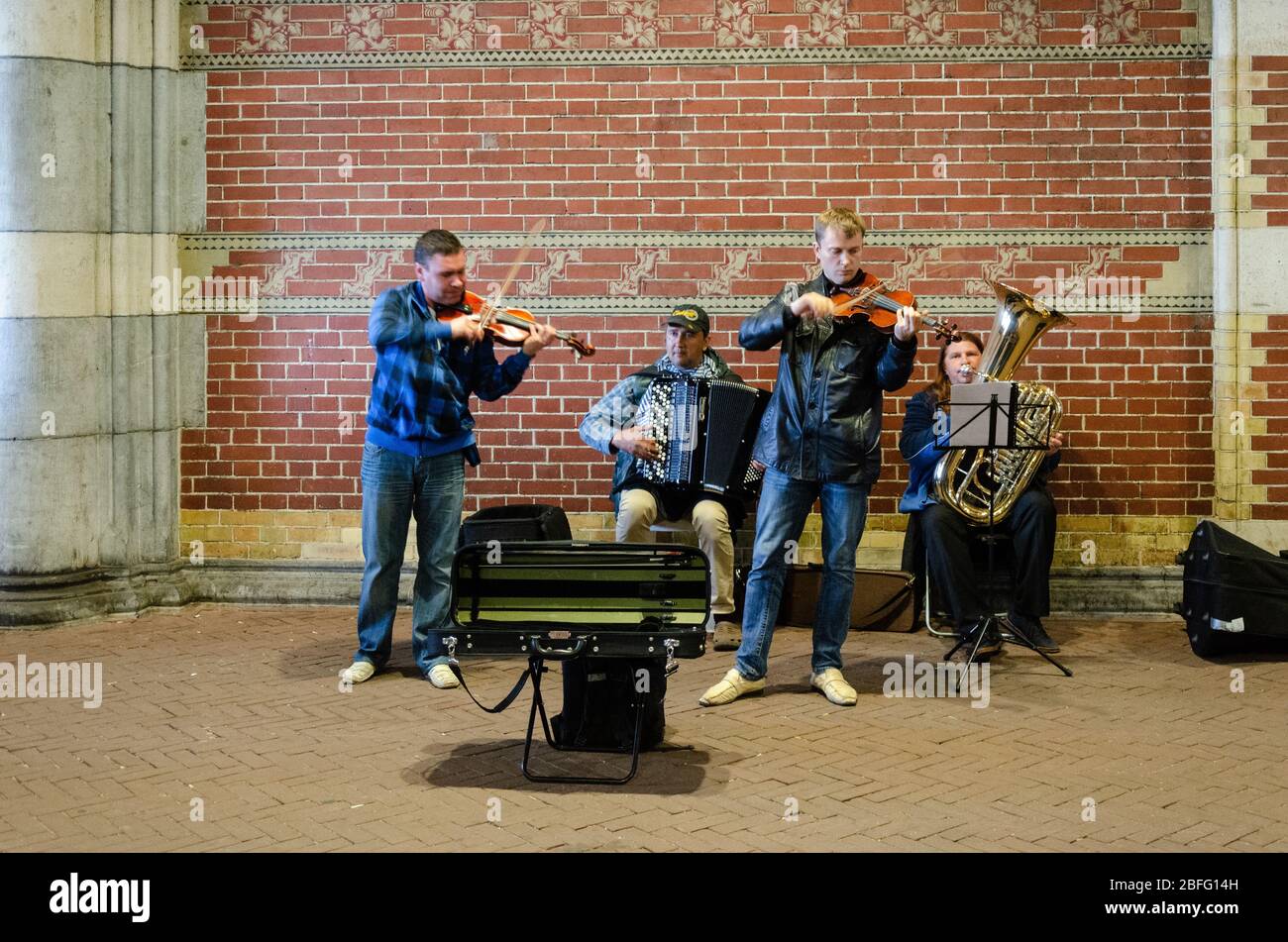 Small band of four people performing on the streets of Amsterdam ...