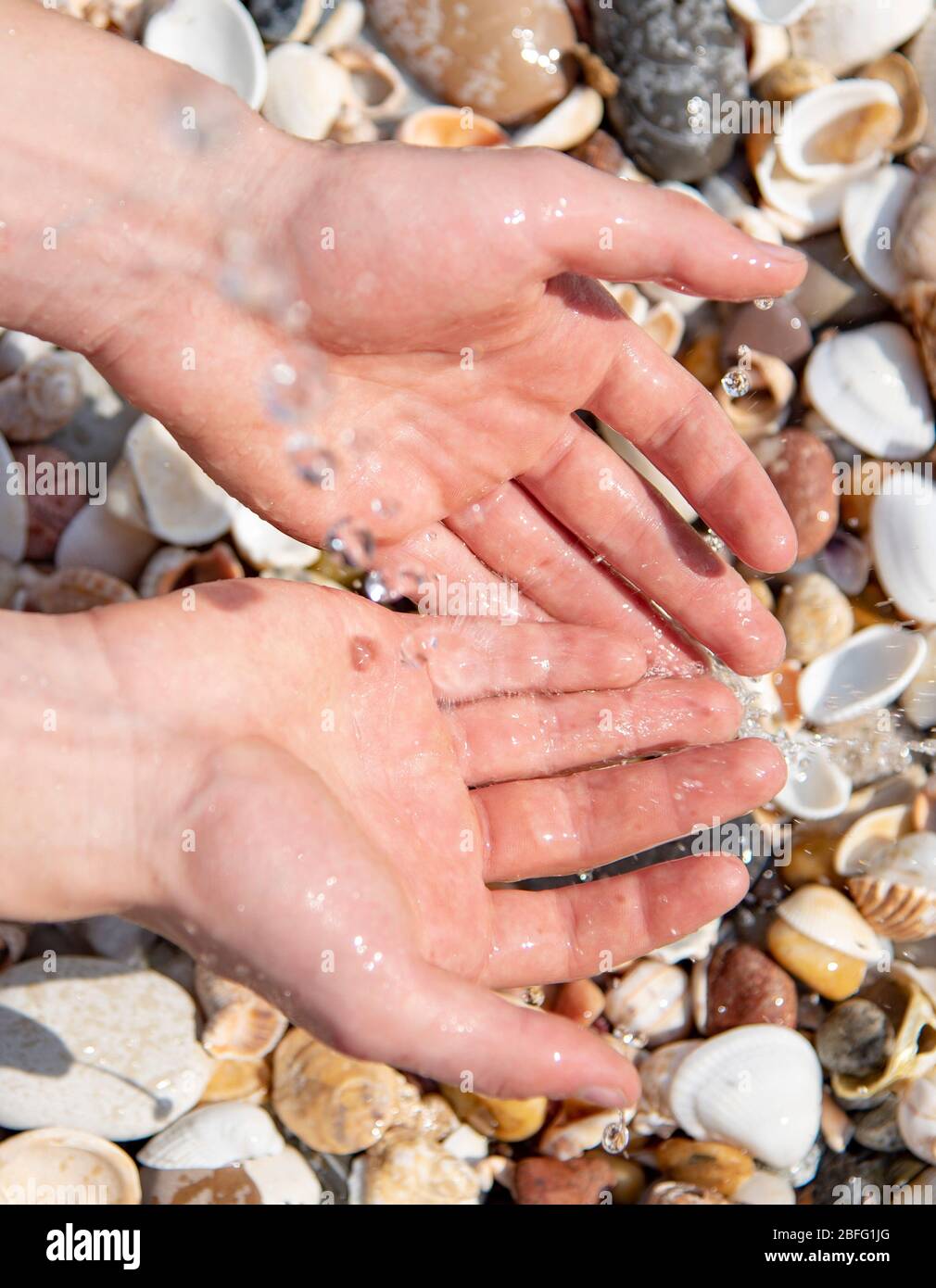 Hands under rocks hi-res stock photography and images - Alamy