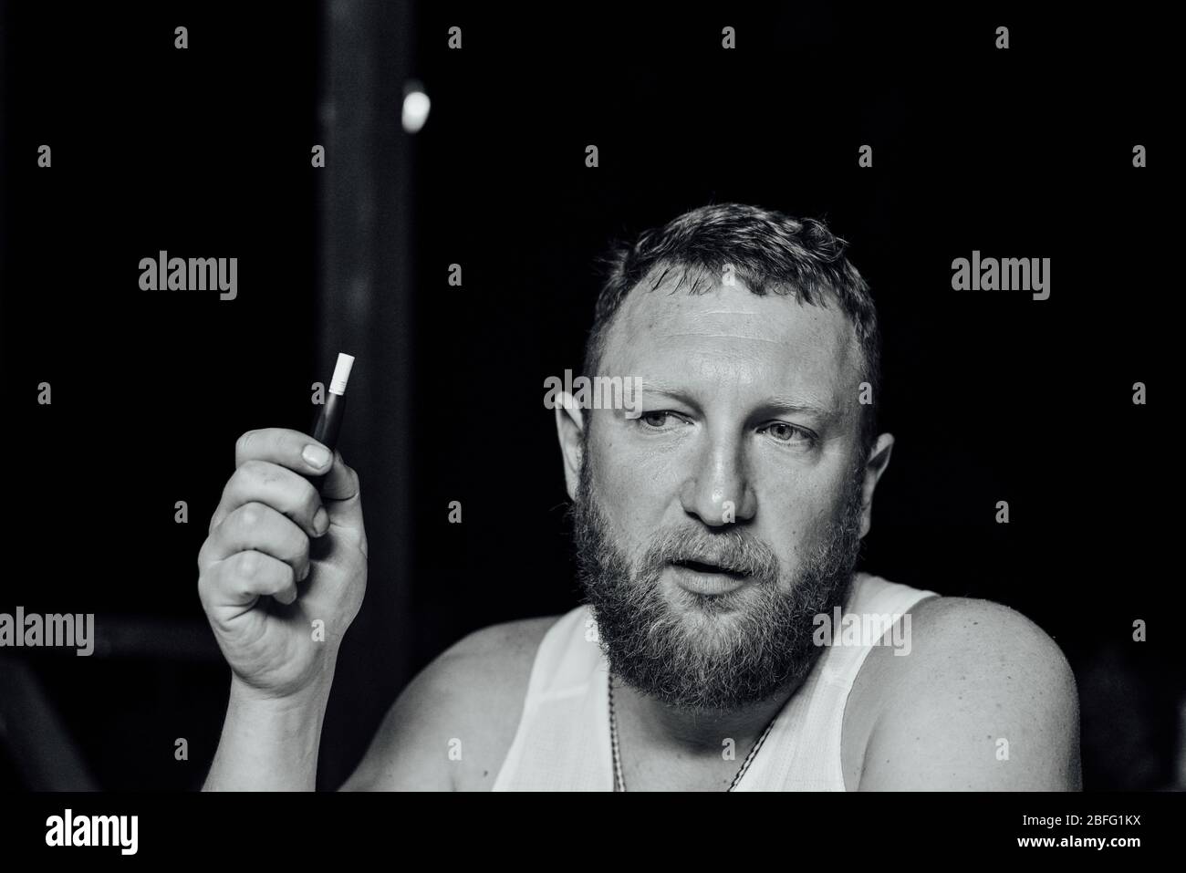 portrait of young grumpy bearded red hair man with sigaret horizontal ...