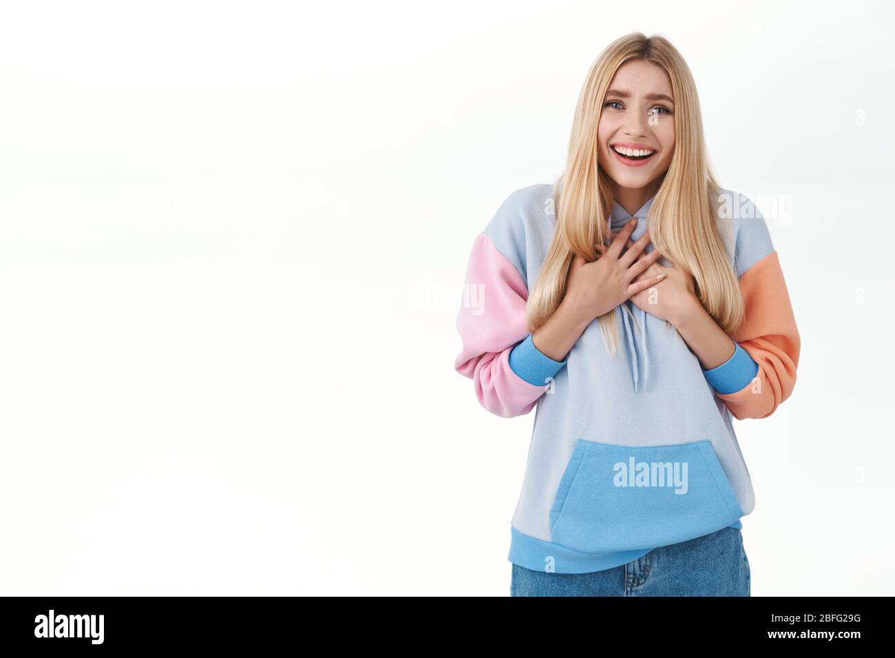 Touched happy, smiling girl feel flattered and delighted to receive ...