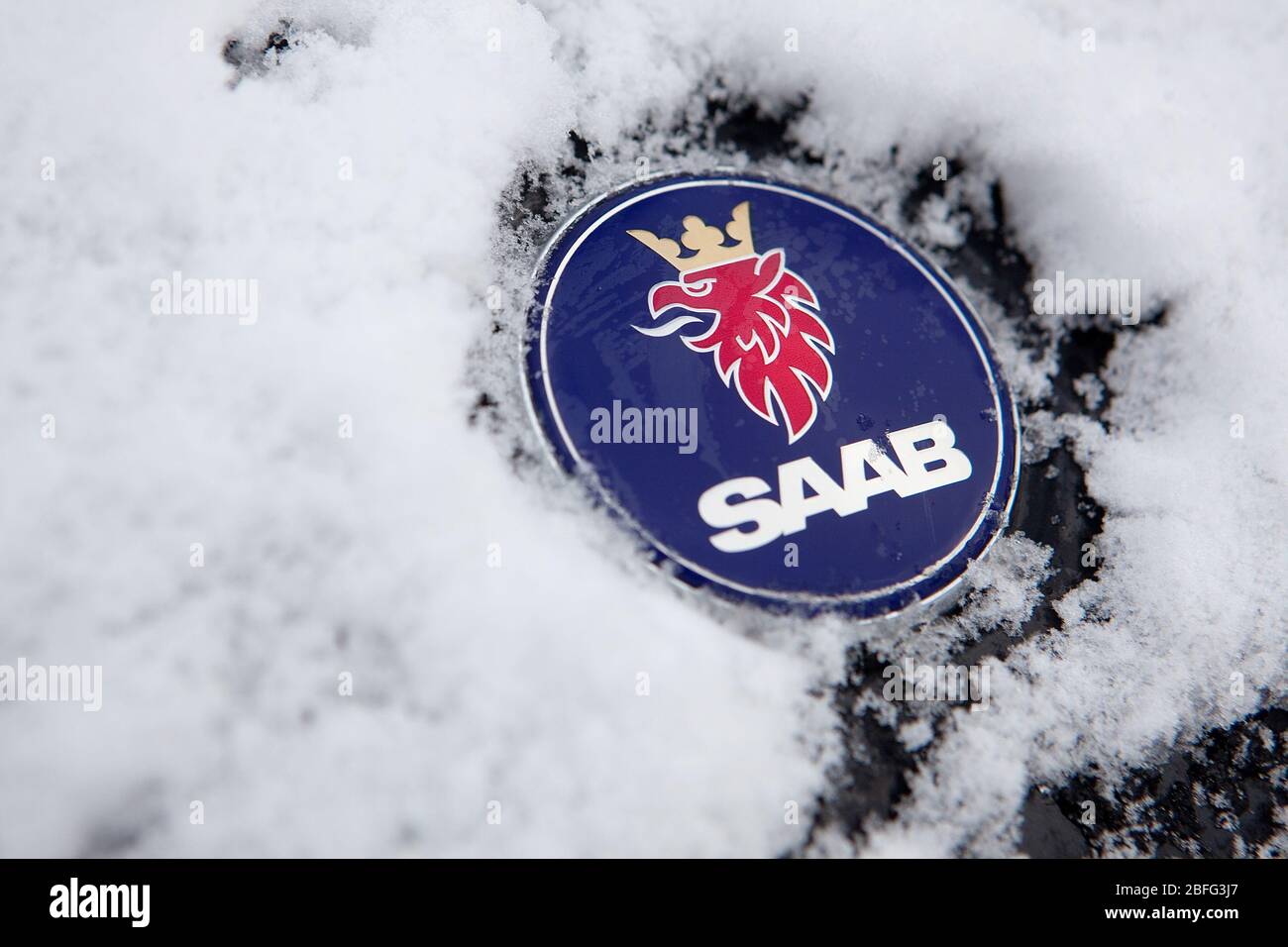 A snow covered Saab car emblem Stock Photo - Alamy
