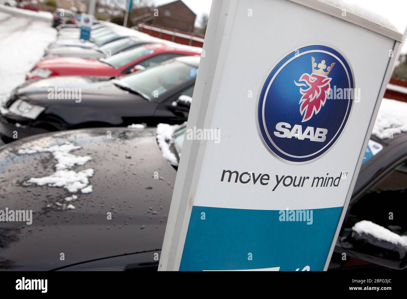 A Saab garage sign, pictured with brand new cars filling the forecourt ...