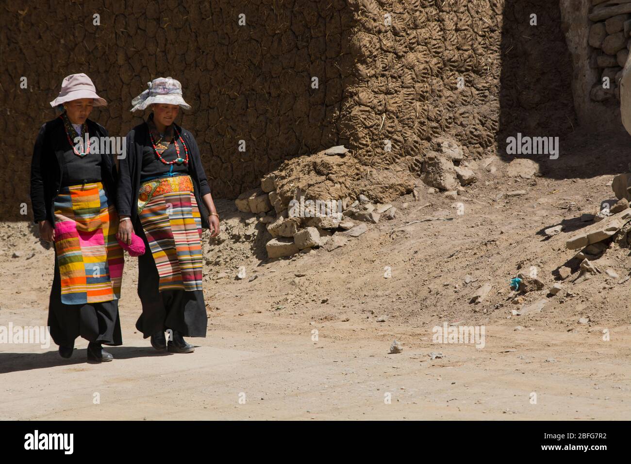 Female pilgrims walk the sacred path (kora) around Shalu Monastery ...