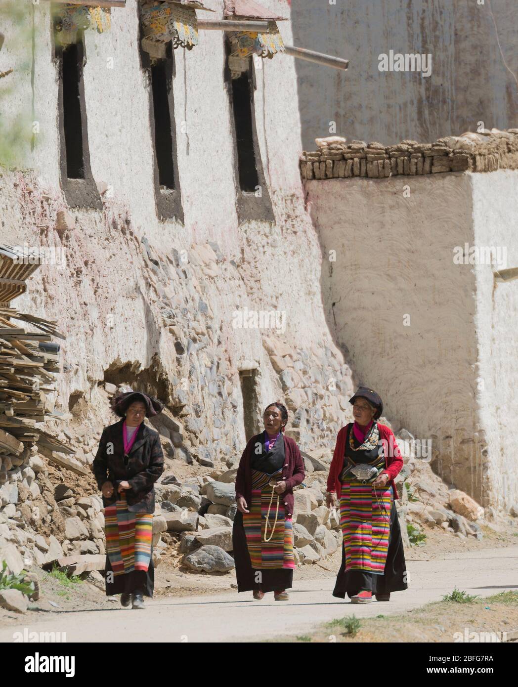 Female pilgrims walk the sacred path (kora) around Shalu Monastery ...
