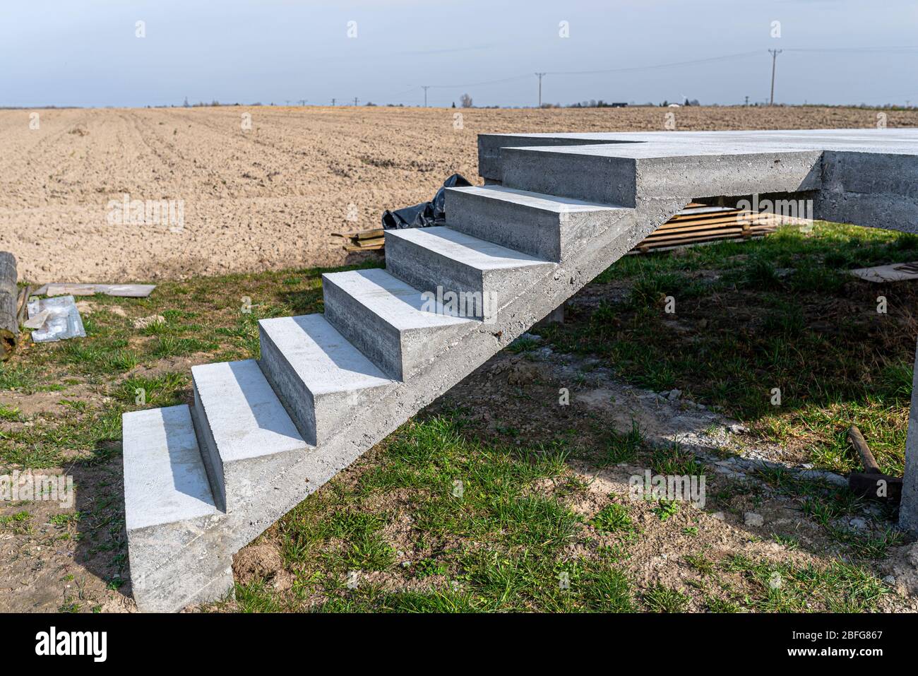 Concrete rectangular structure on concrete poles with stairs in raw ...
