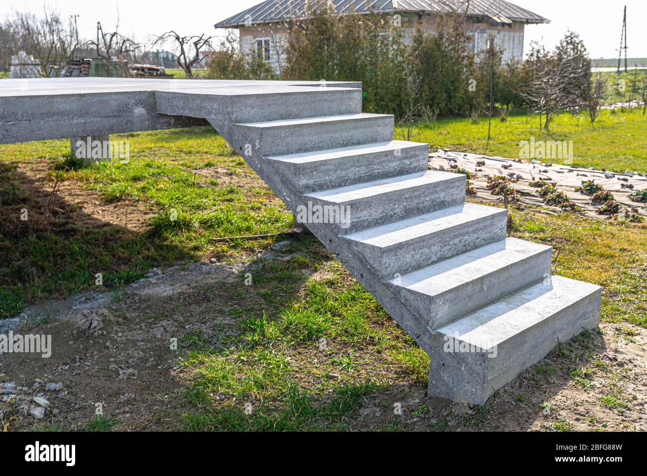Concrete rectangular structure on concrete poles with stairs in raw ...