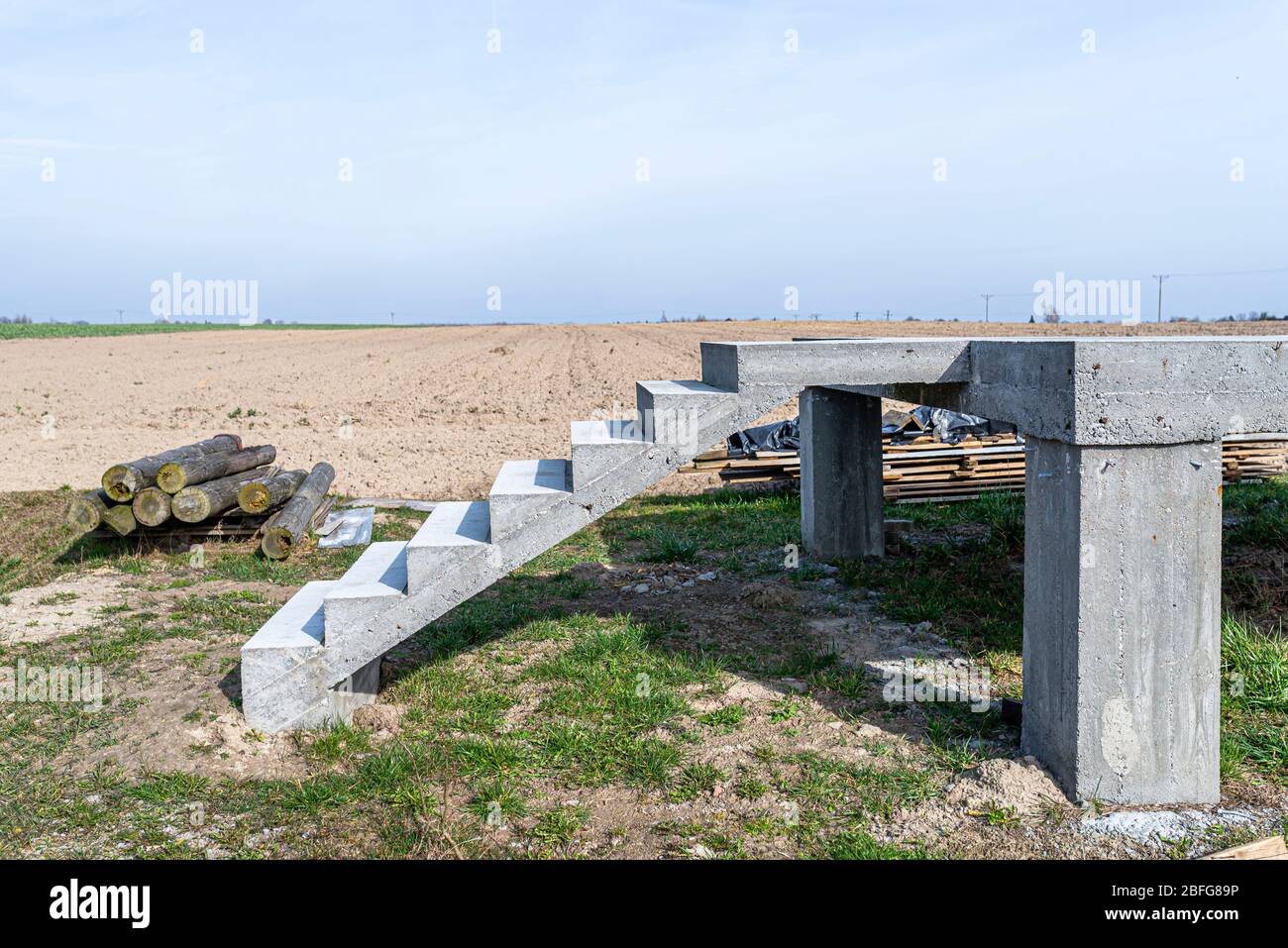 Concrete rectangular structure on concrete poles with stairs in raw ...