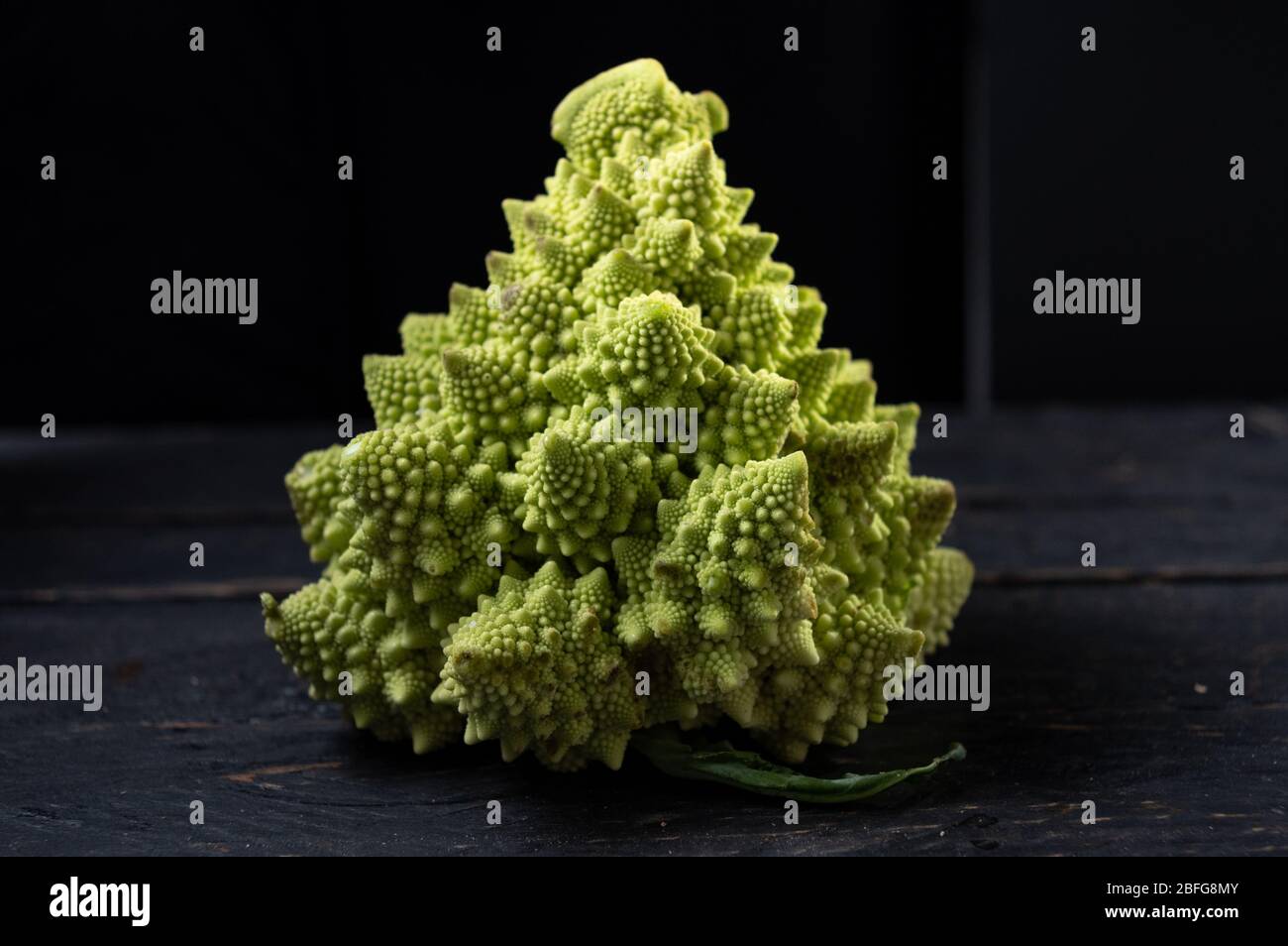 Green triangular cabbage on a black background. Macro photo of a ...
