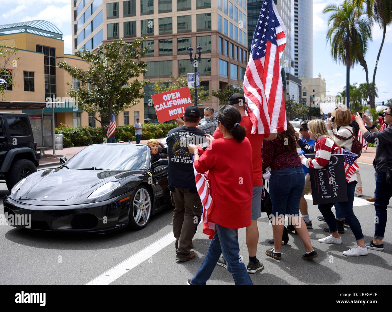 Man wearing President Trump mask drives by a Freedom Rally during the ...