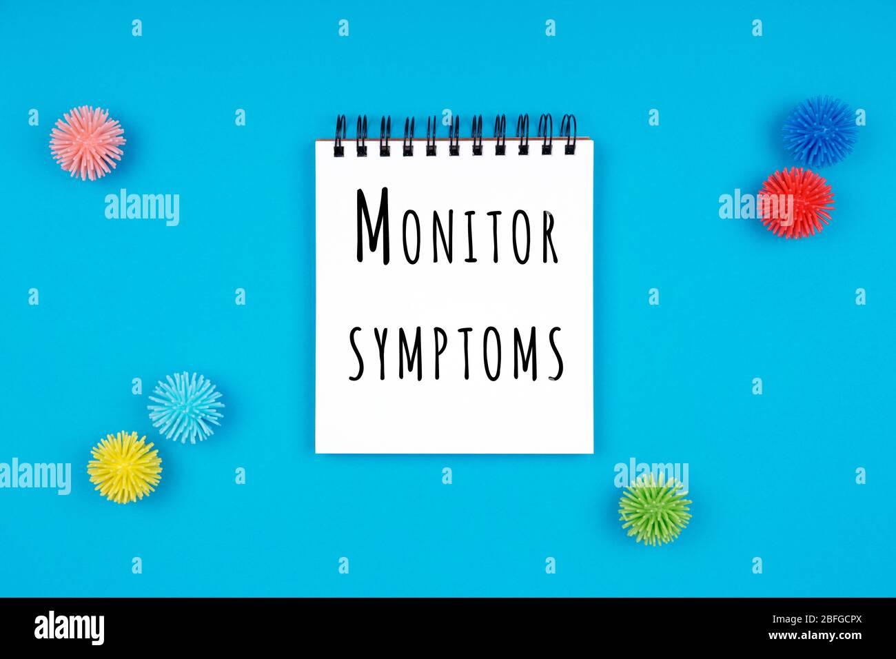 Paper notebook with plastic balls as viruses on the blue background ...