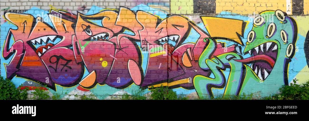 Abstract colorful fragment of graffiti paintings on old brick wall with ...