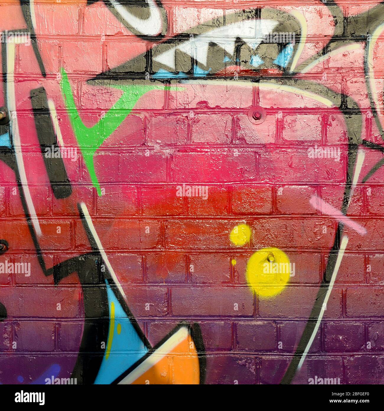 Abstract colorful fragment of graffiti paintings on old brick wall ...