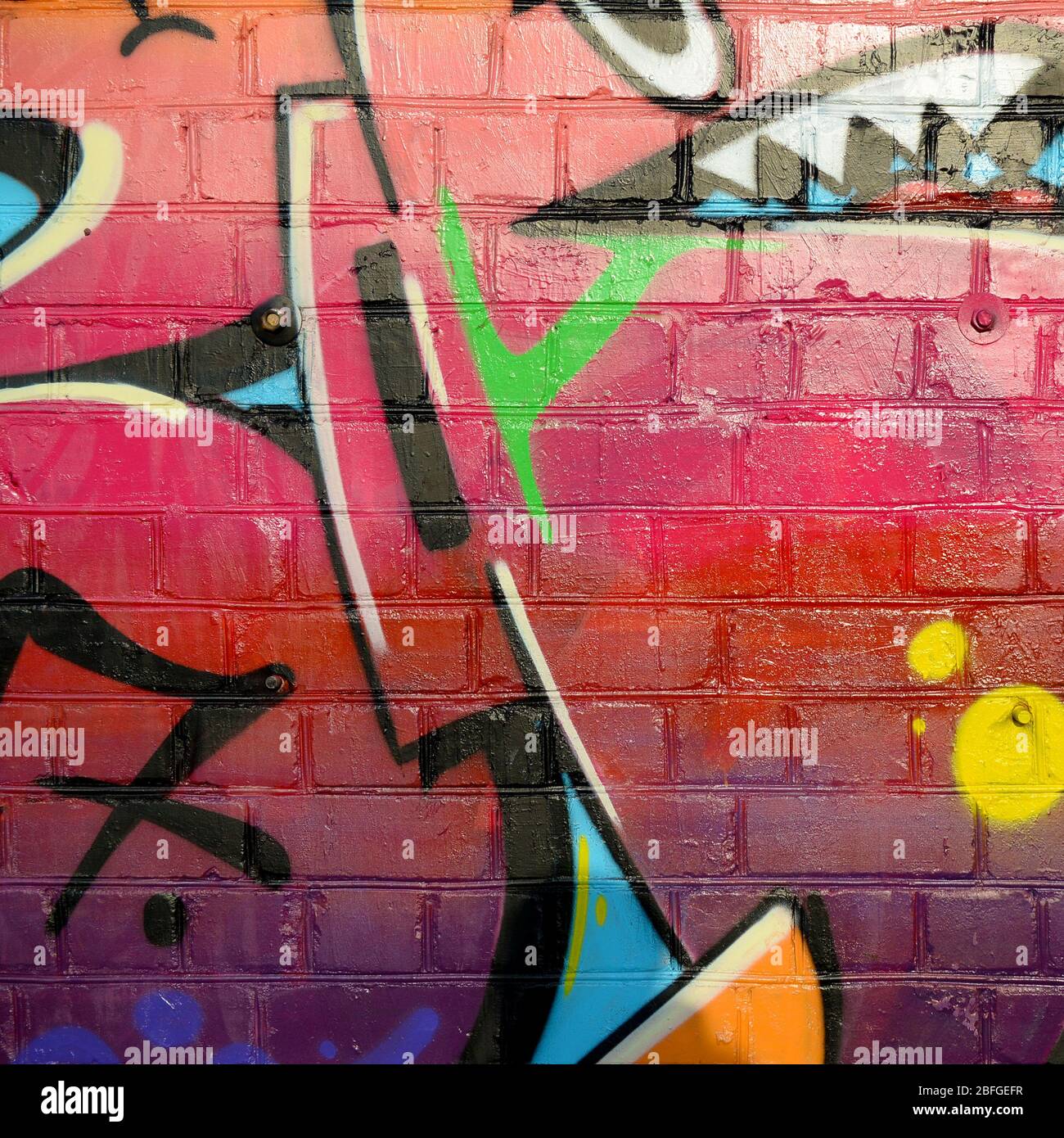 Abstract colorful fragment of graffiti paintings on old brick wall ...