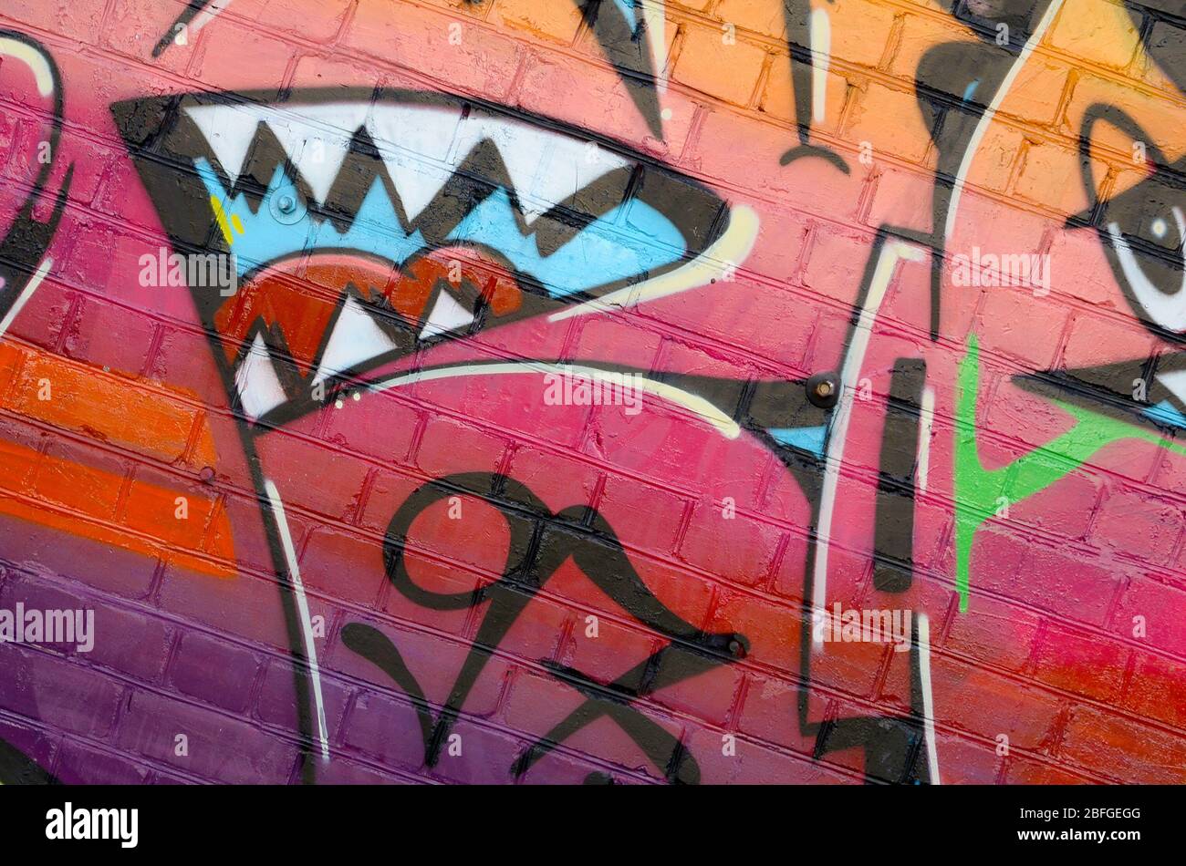 Abstract colorful fragment of graffiti paintings on old brick wall ...