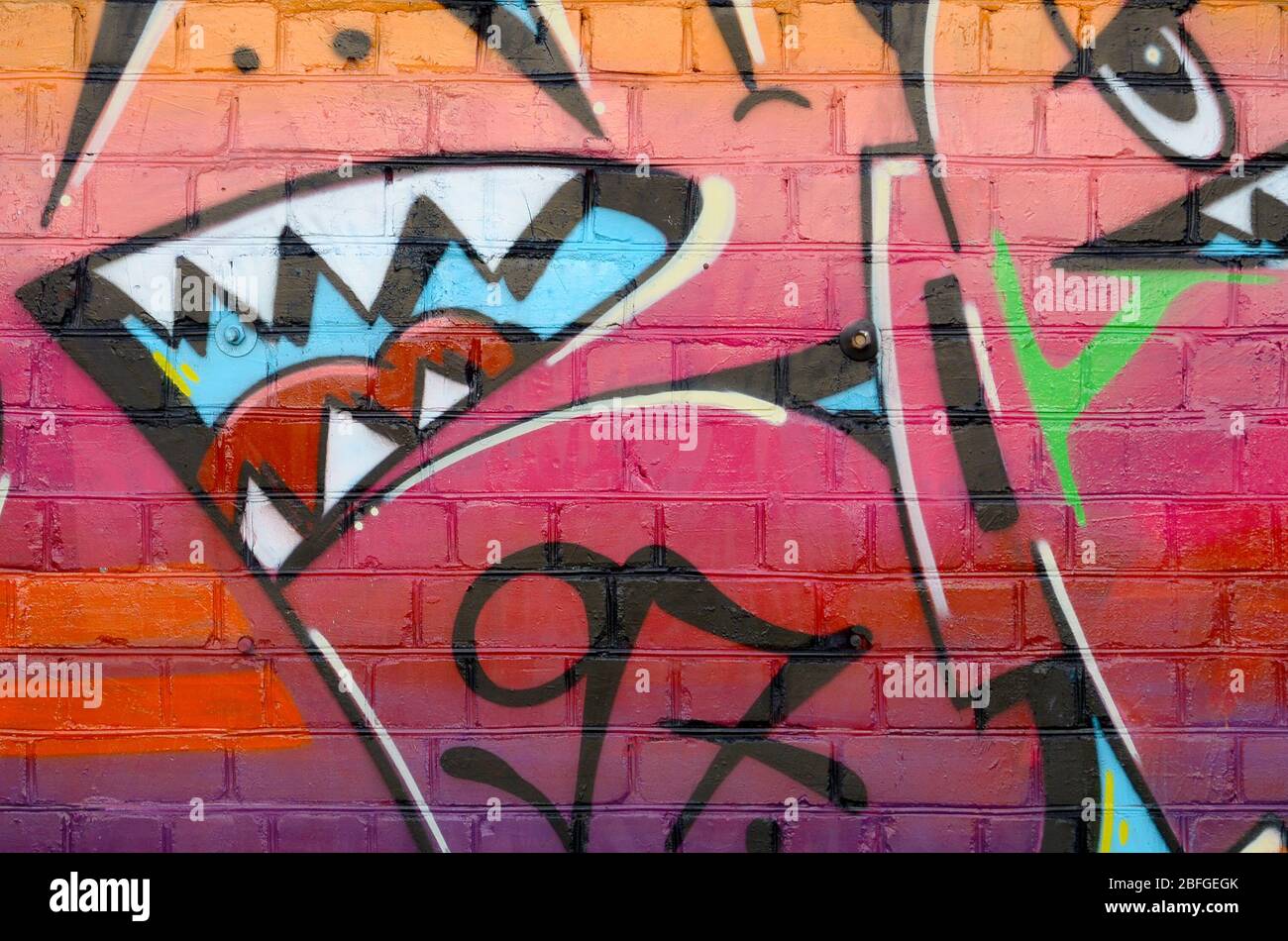 Abstract colorful fragment of graffiti paintings on old brick wall ...