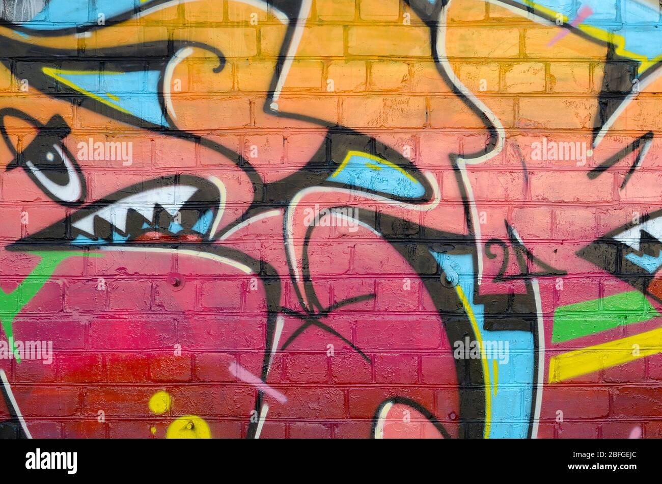 Abstract colorful fragment of graffiti paintings on old brick wall ...