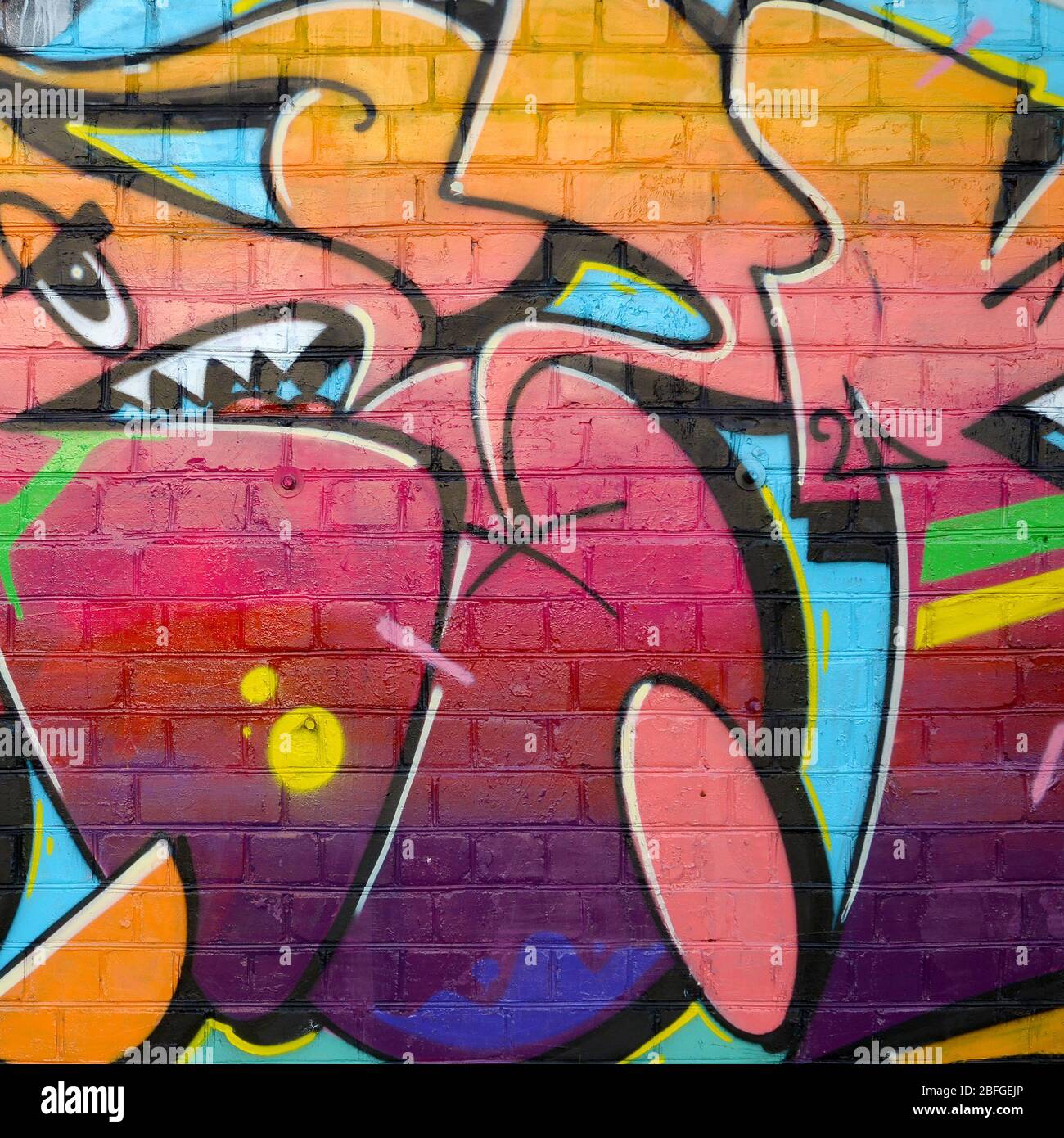 Abstract colorful fragment of graffiti paintings on old brick wall ...