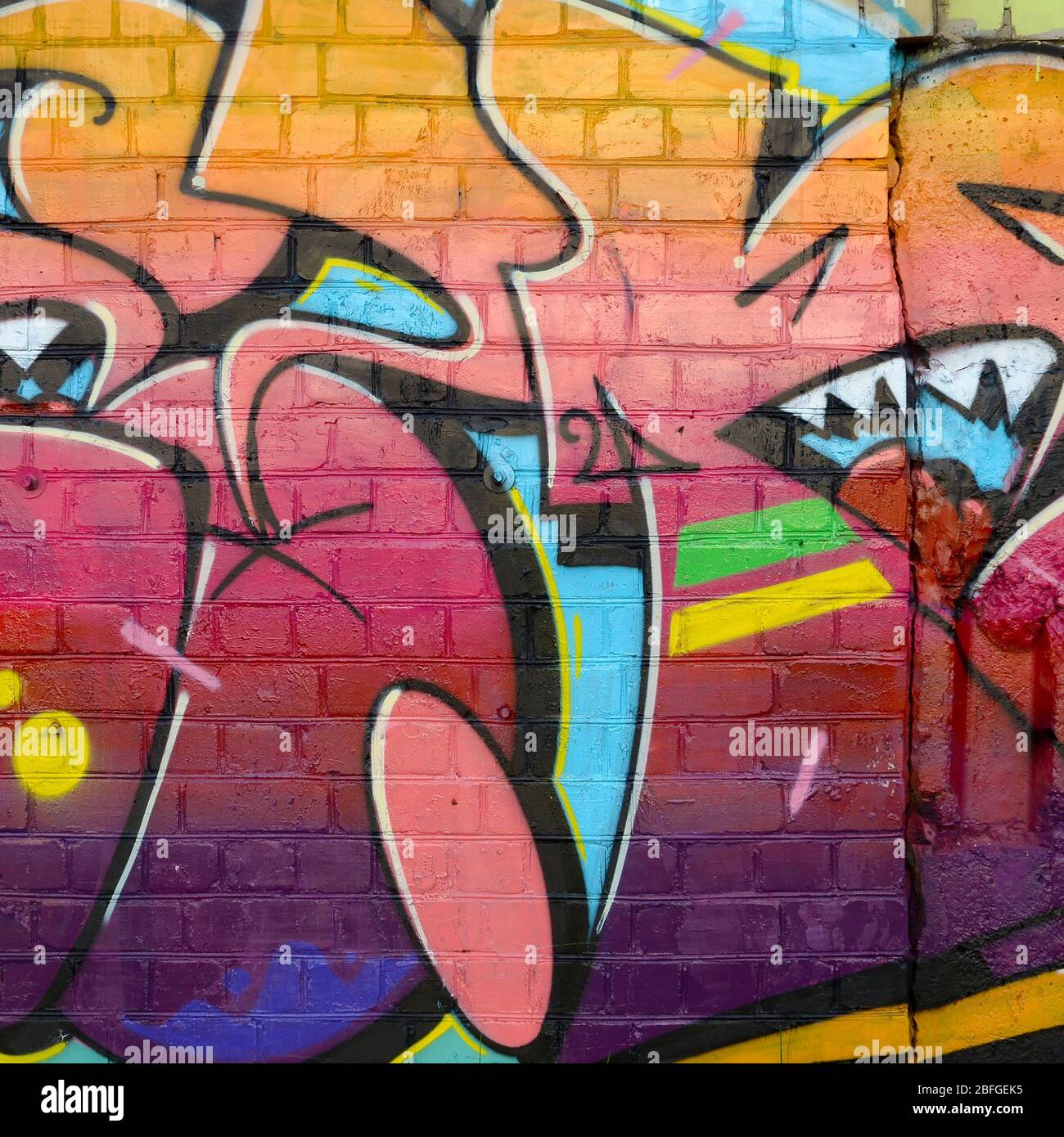 Abstract colorful fragment of graffiti paintings on old brick wall ...