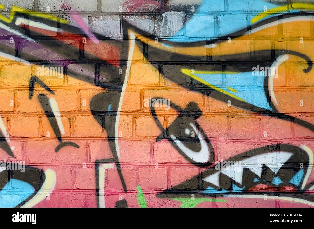 Abstract colorful fragment of graffiti paintings on old brick wall ...