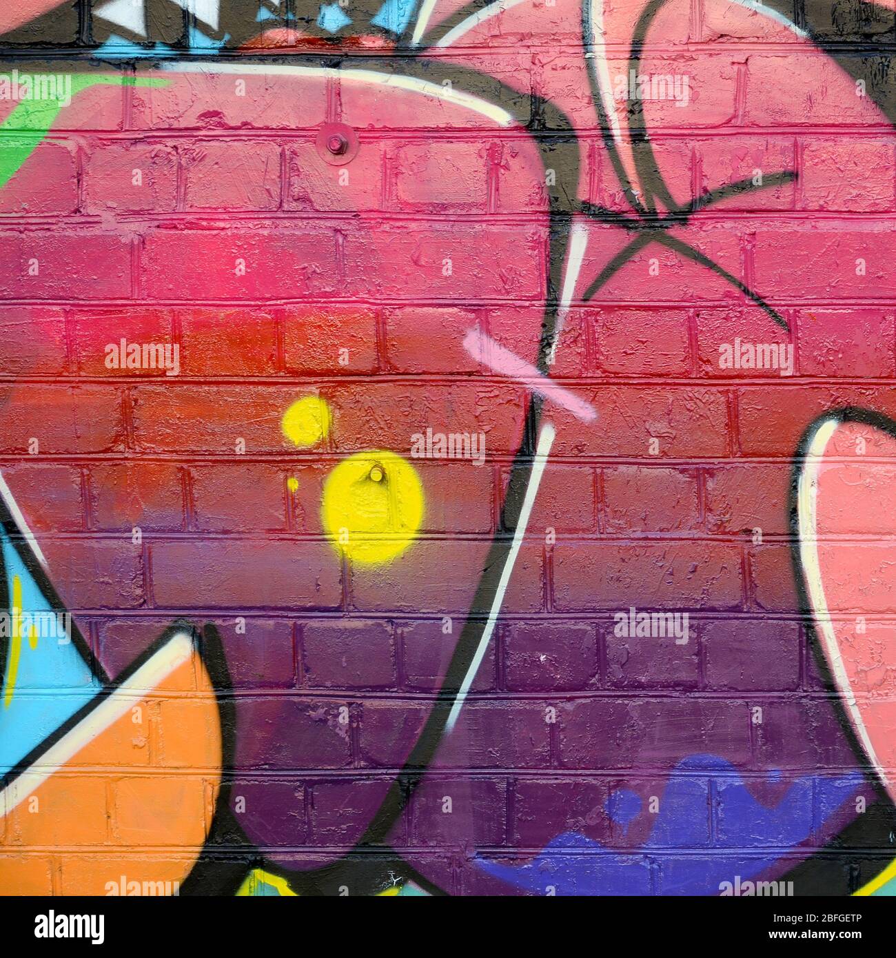 Abstract colorful fragment of graffiti paintings on old brick wall ...