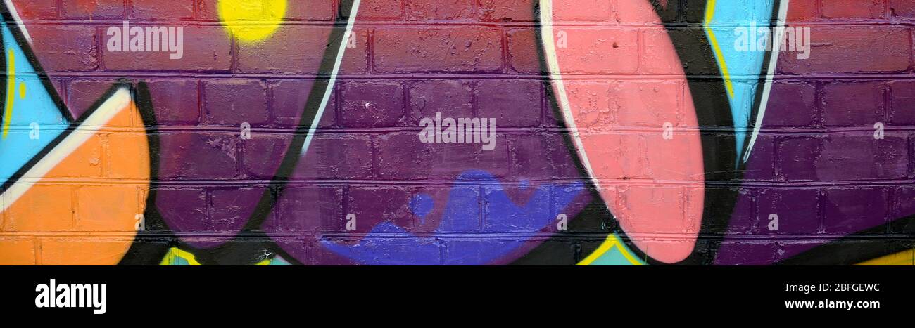 Abstract colorful fragment of graffiti paintings on old brick wall ...