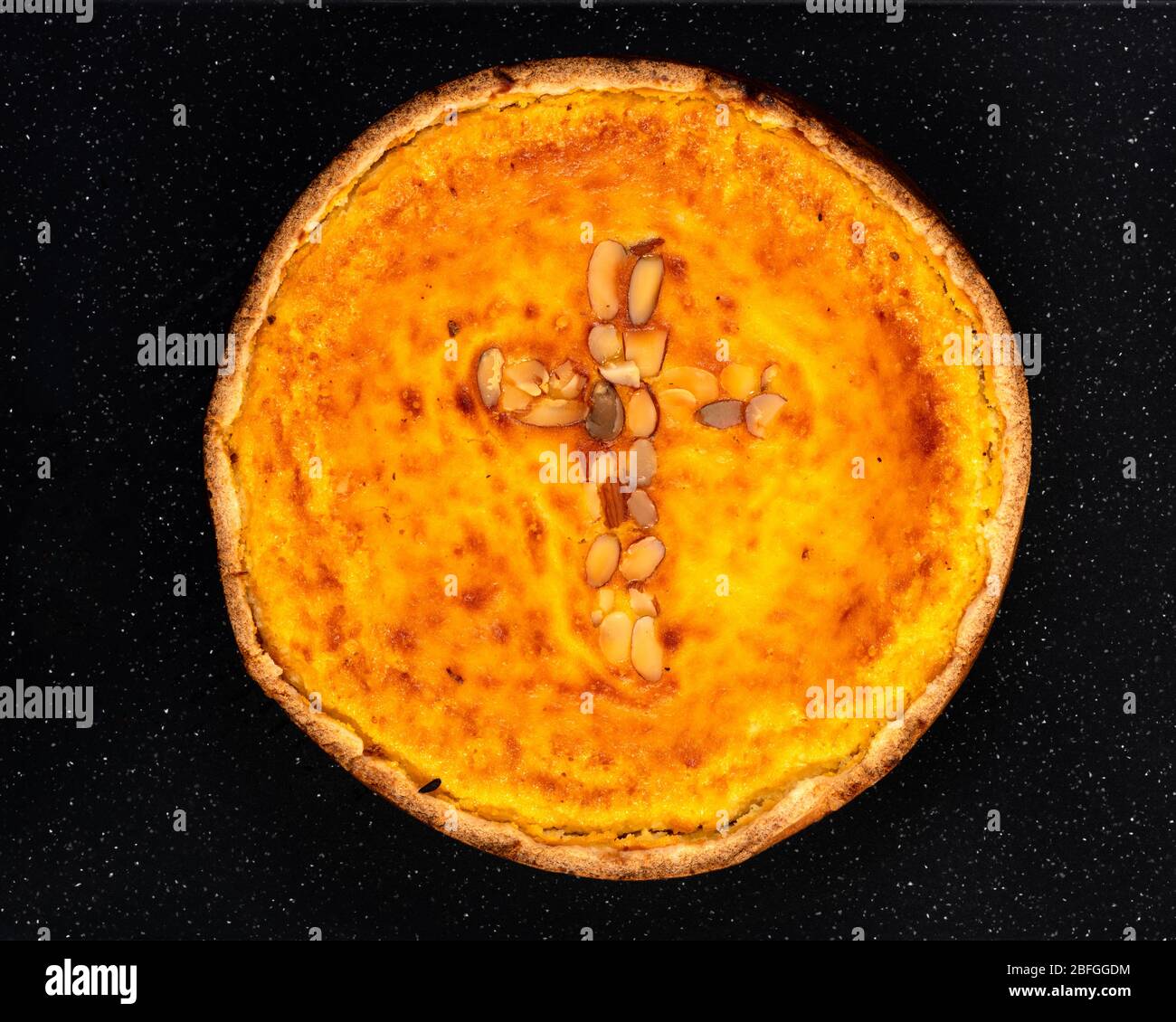 Traditional romanian cake called Pasca with an almond cross isolated on ...