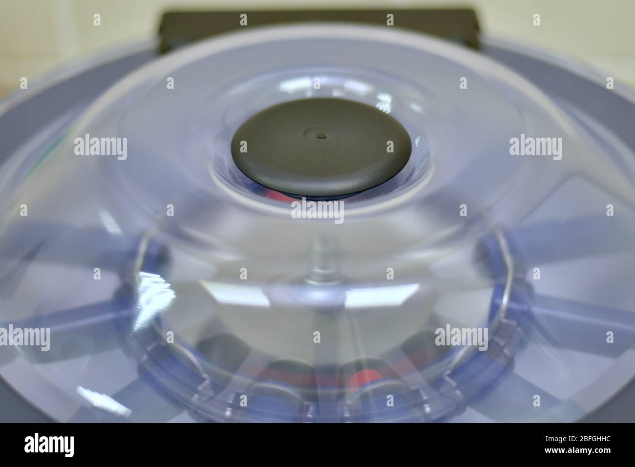 Closed laboratory centrifuge with test tubes in compartments view from ...