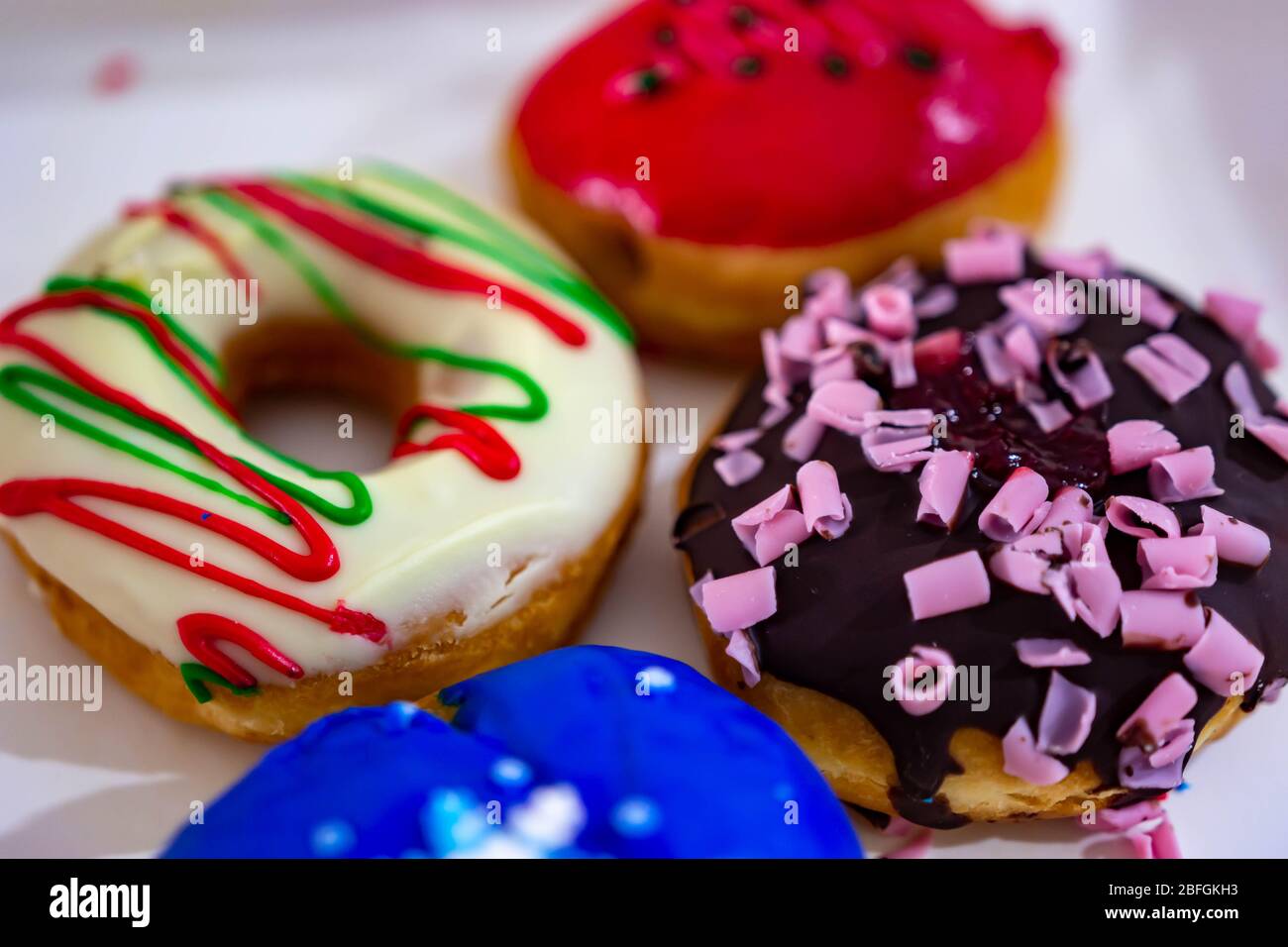 Colorful blue, red, brown and stripe donuts with white background Stock ...