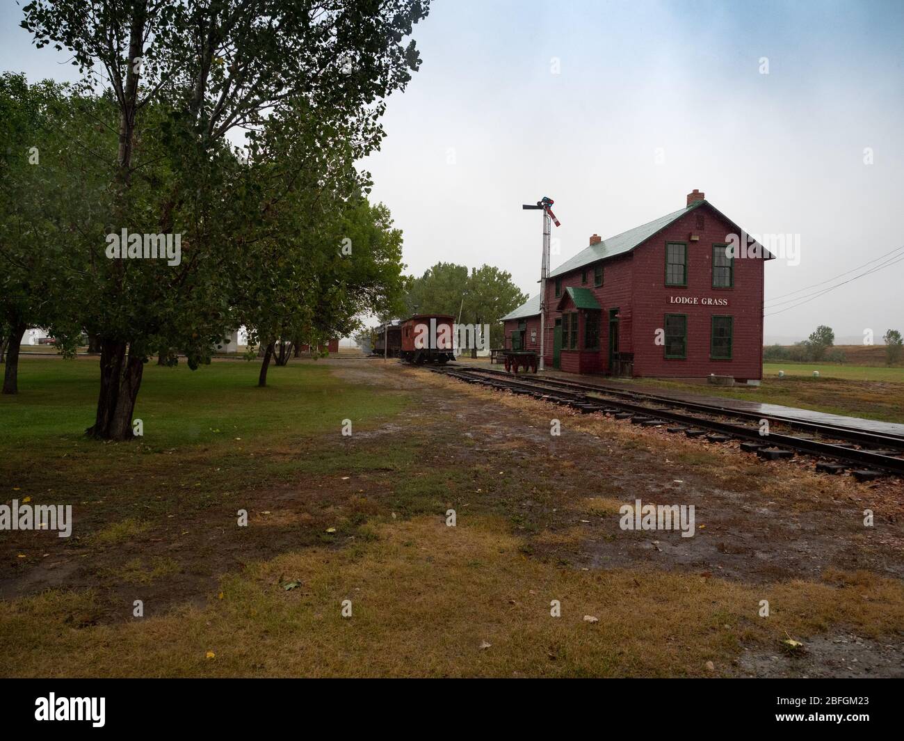 Restored wooden train depot with tracks and a train car at the Big Horn ...