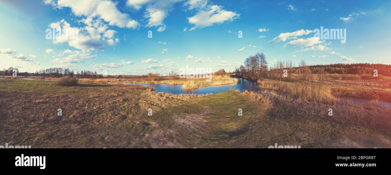Aerial panoramic view of countryside and brook in the evening at sunset ...
