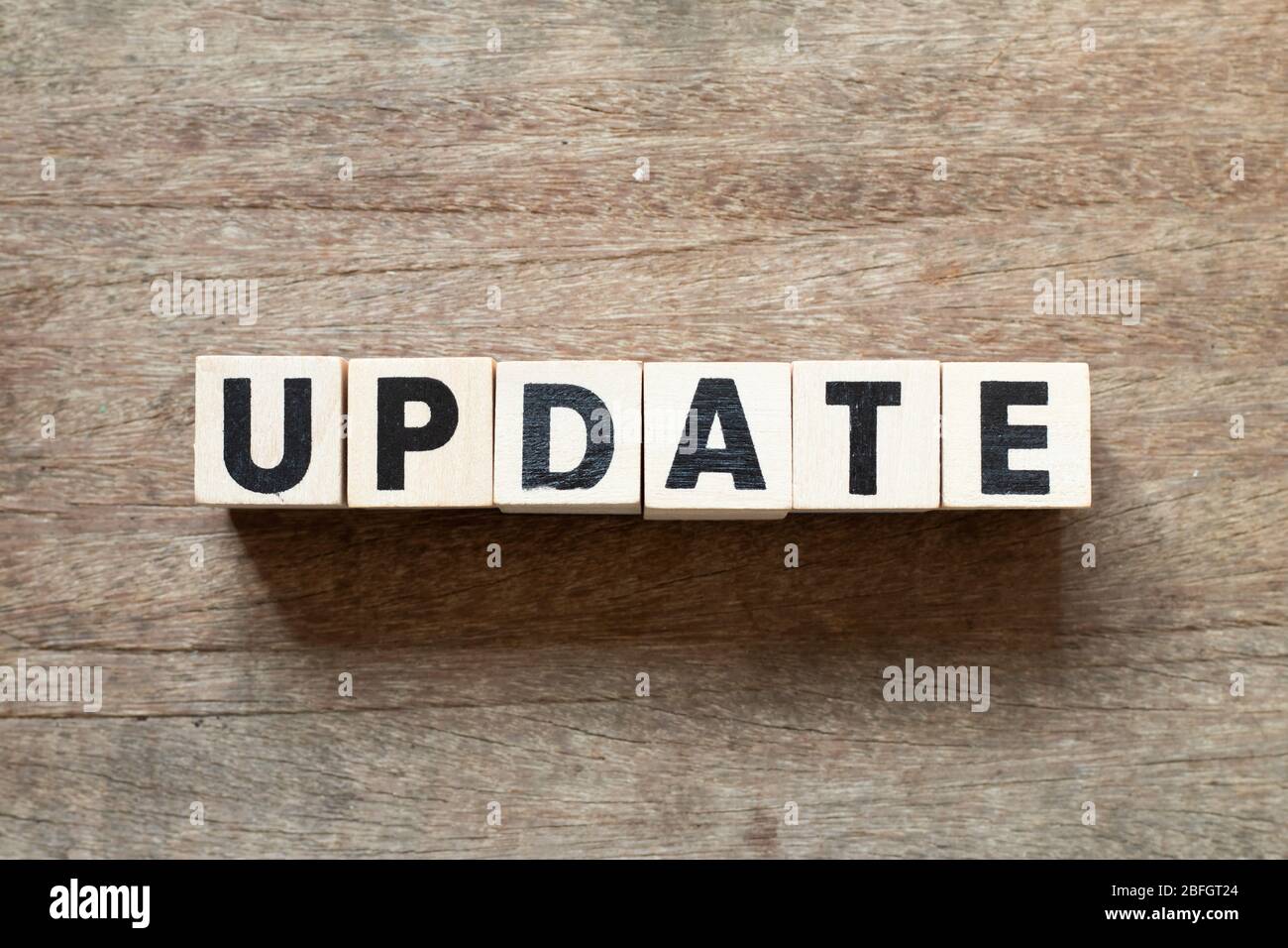 Letter block in word update on wood background Stock Photo - Alamy