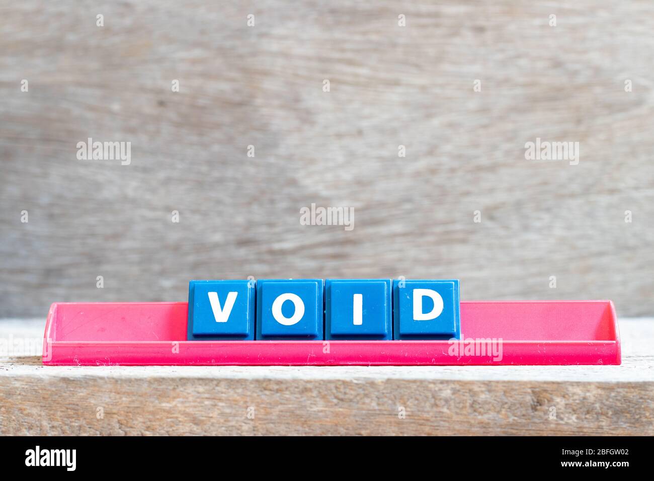 Tile letter on red rack in word void on wood background Stock Photo - Alamy