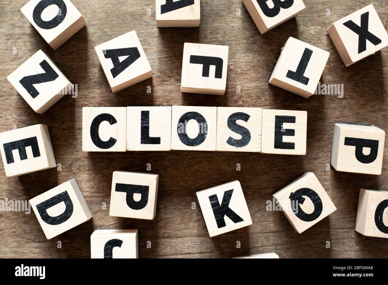 Wood letter block in word close on wood background with another ...