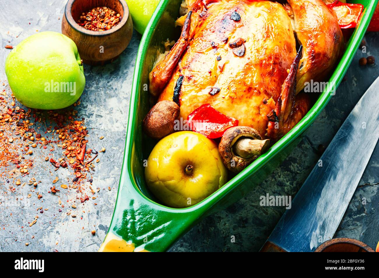 Appetizing baked chicken with apples in baking dish Stock Photo - Alamy