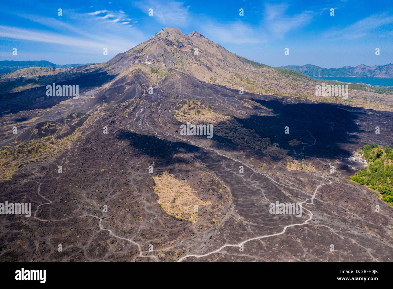 Aerial view of solidified black volcanic lava flows around the slopes ...