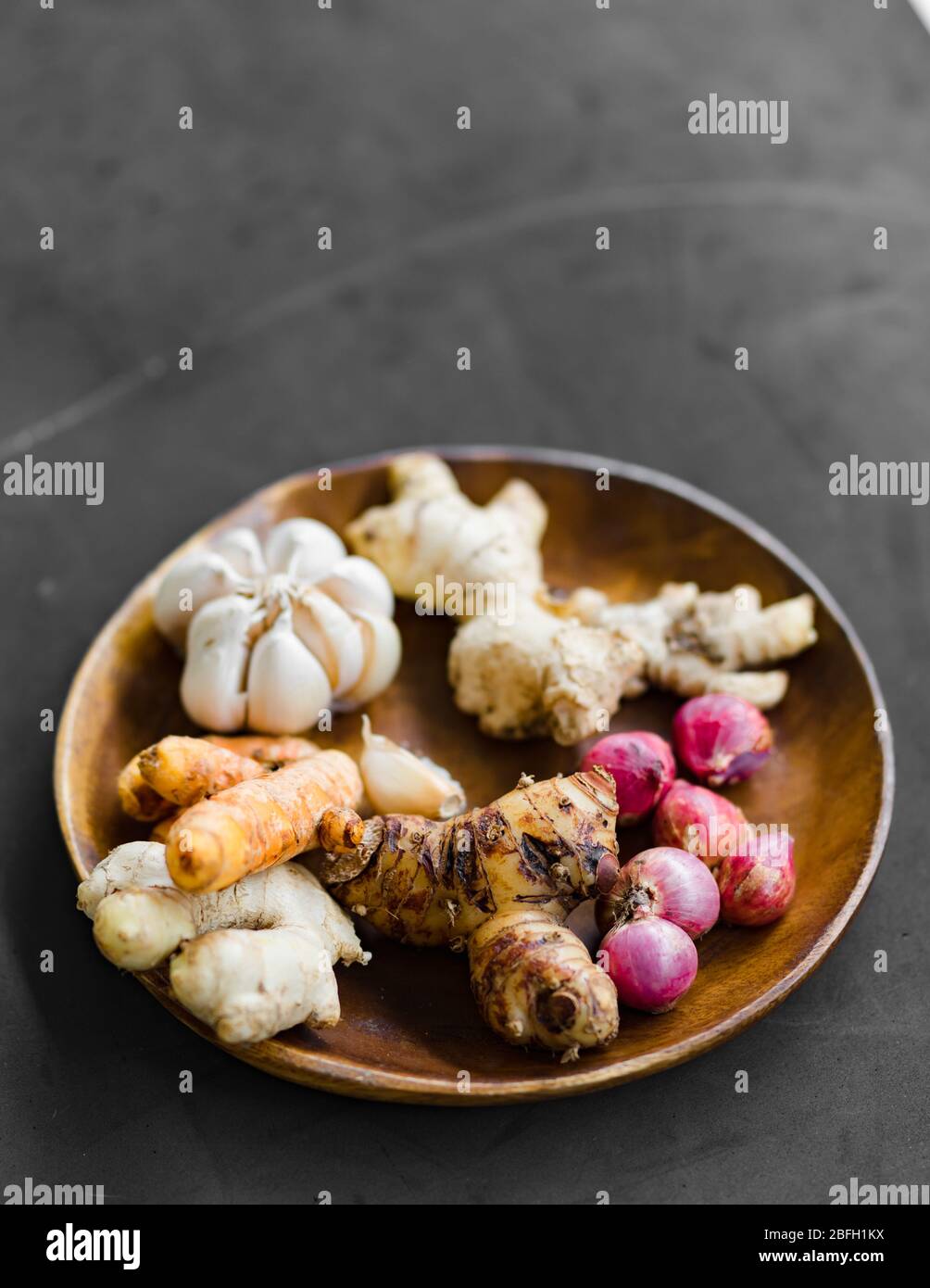 Basic seasoning ingredients in a wooden plate Stock Photo - Alamy