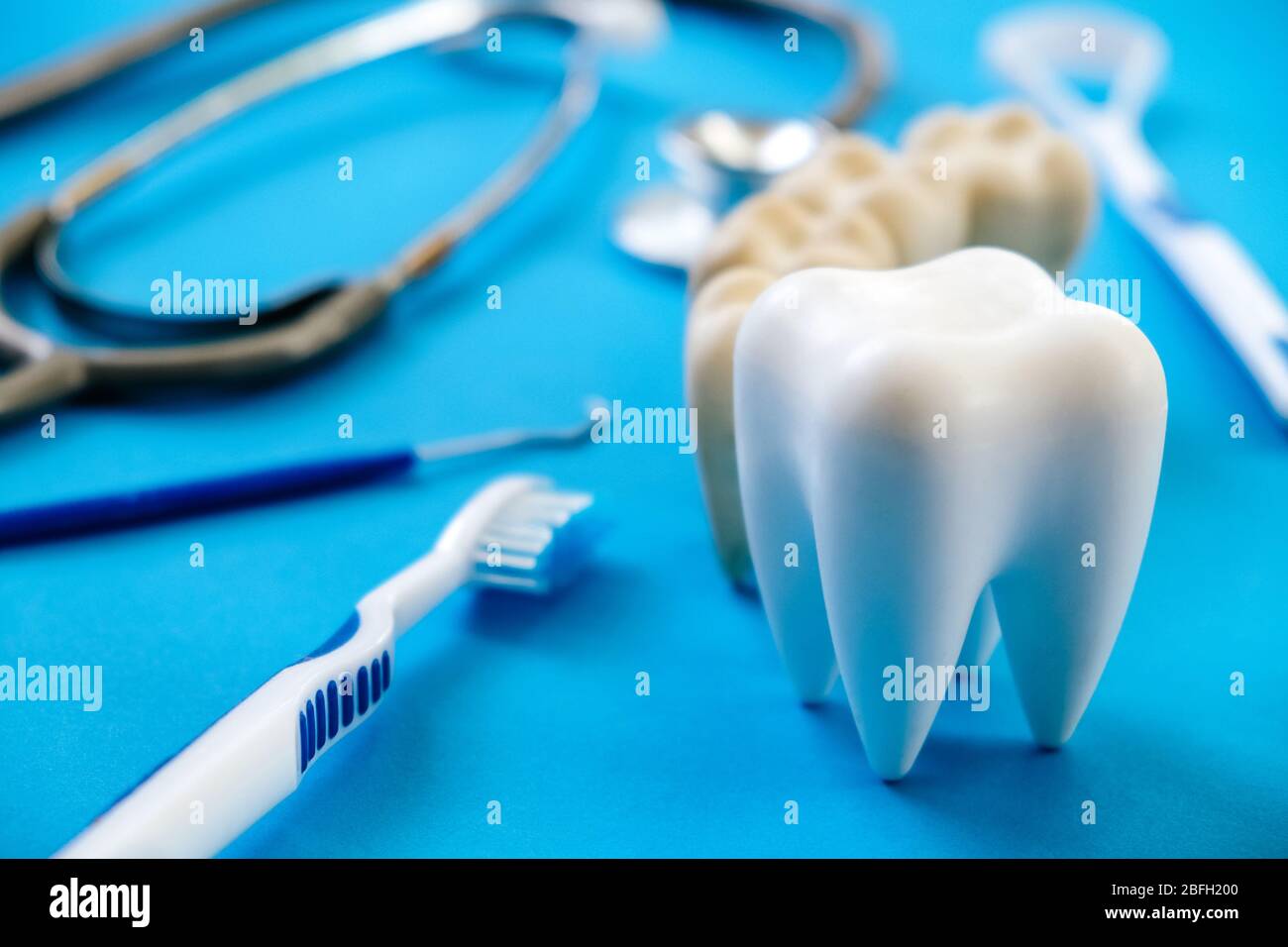 Dental model and dental equipment on blue background, concept image of ...