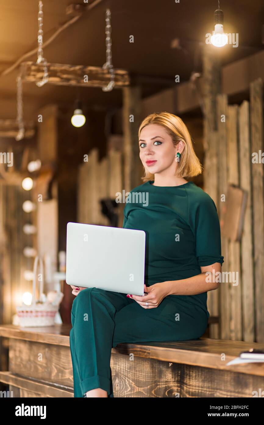 Cheerful elegant blonde business woman, administrator wearing emerald ...