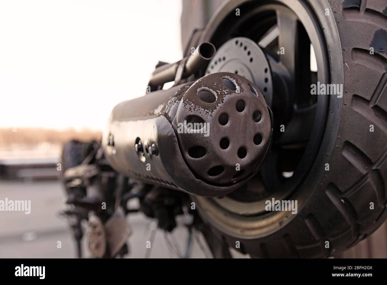 the rear wheel and exhaust pipe on a broken moped Stock Photo - Alamy