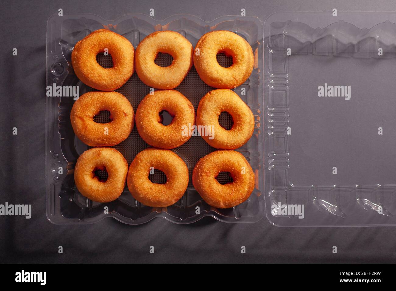 Delicious donuts in a plastic container Stock Photo - Alamy