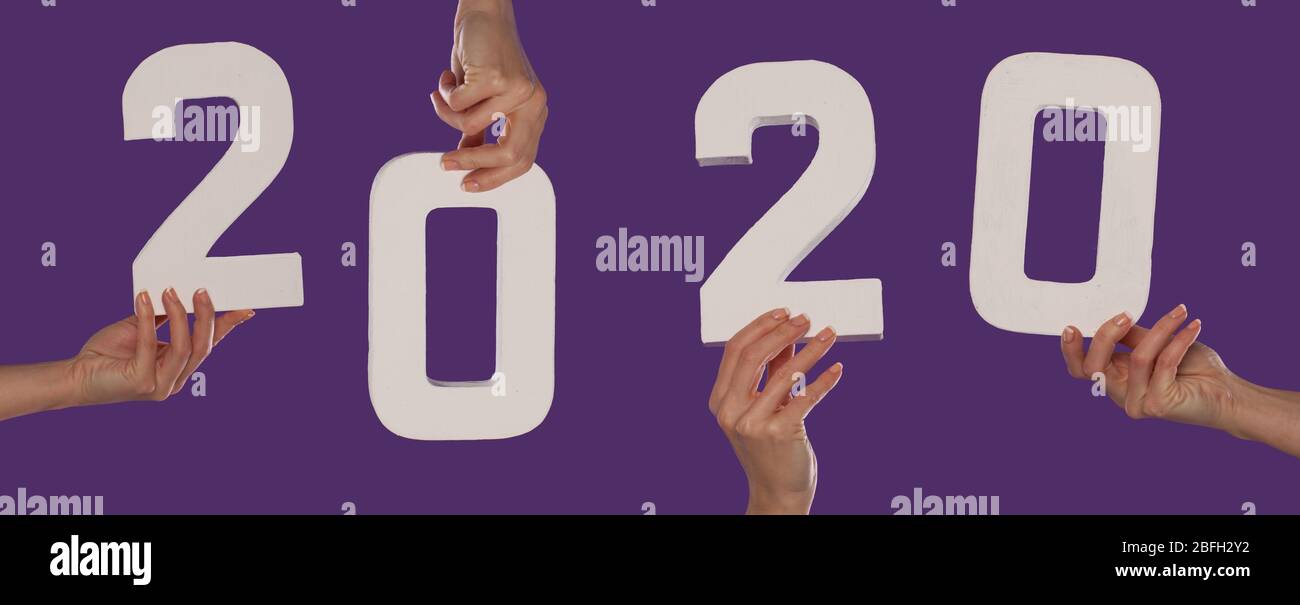 Female hand holding up the number 2 against a purple background ...