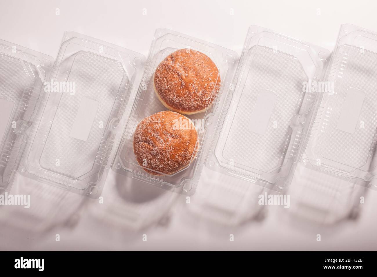Delicious donuts in a plastic container Stock Photo - Alamy