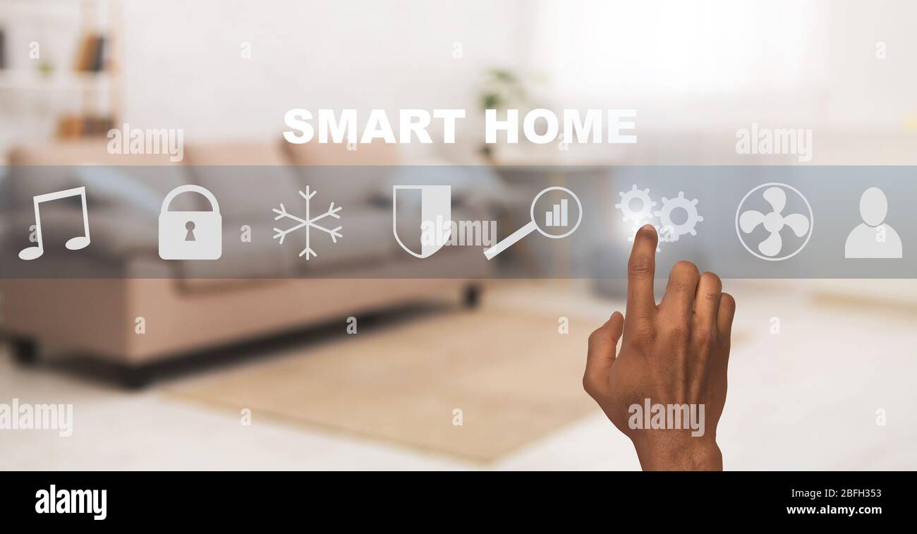 African American man using smart home automation control system ...