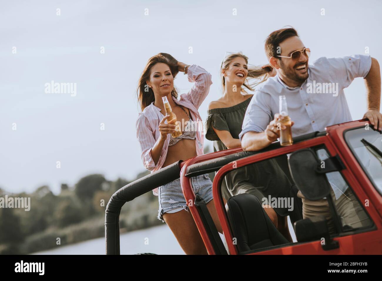 Group of happy young people enjoying road trip Stock Photo - Alamy