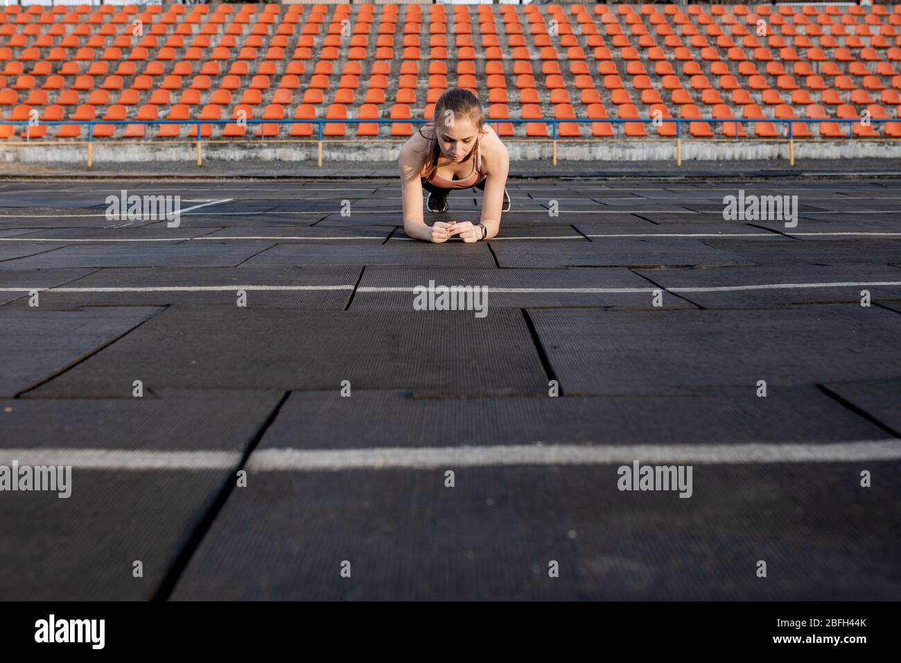 Female athlete preparing legs for cardio workout. Fitness runner doing ...