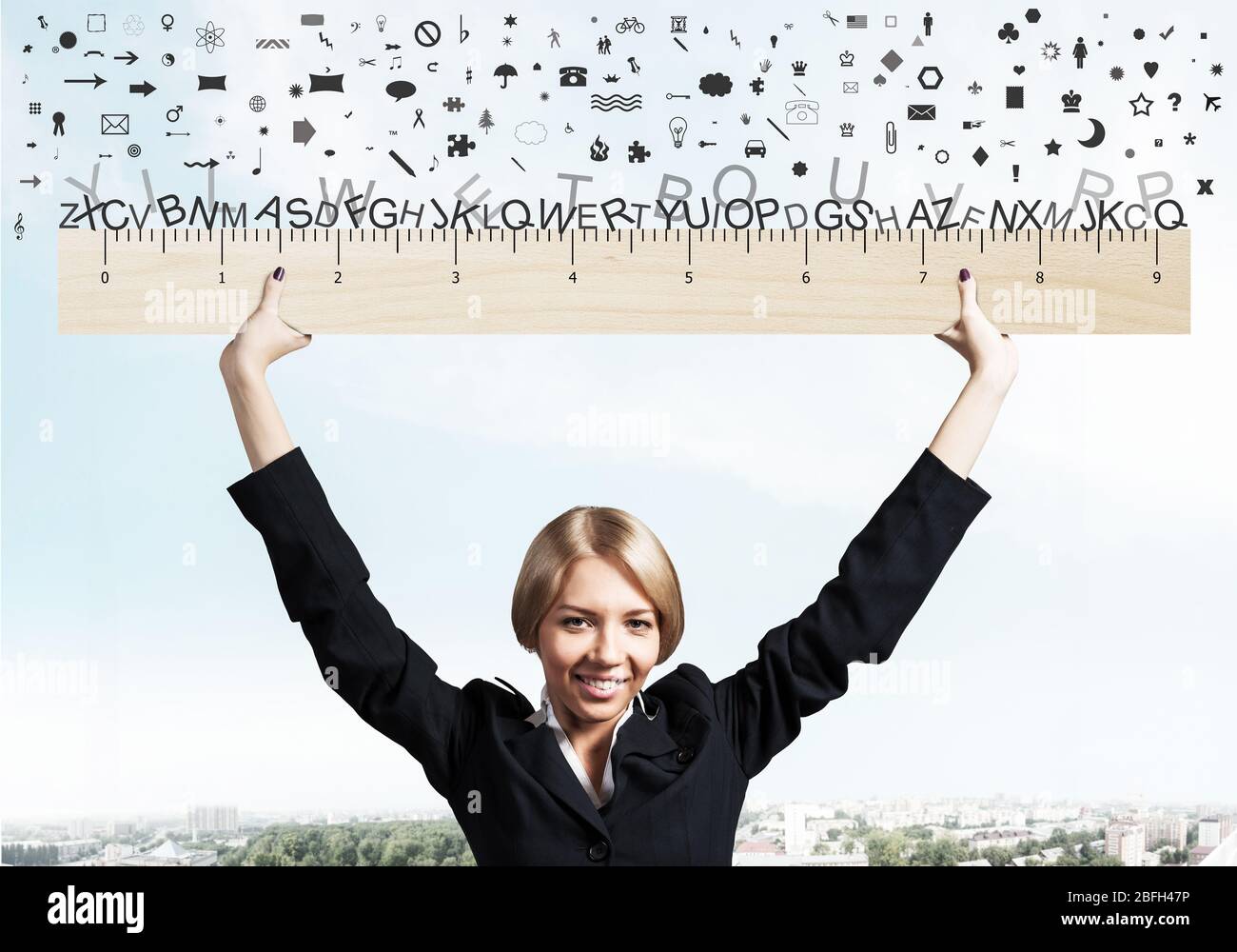 Woman in business suit holding big ruler Stock Photo - Alamy