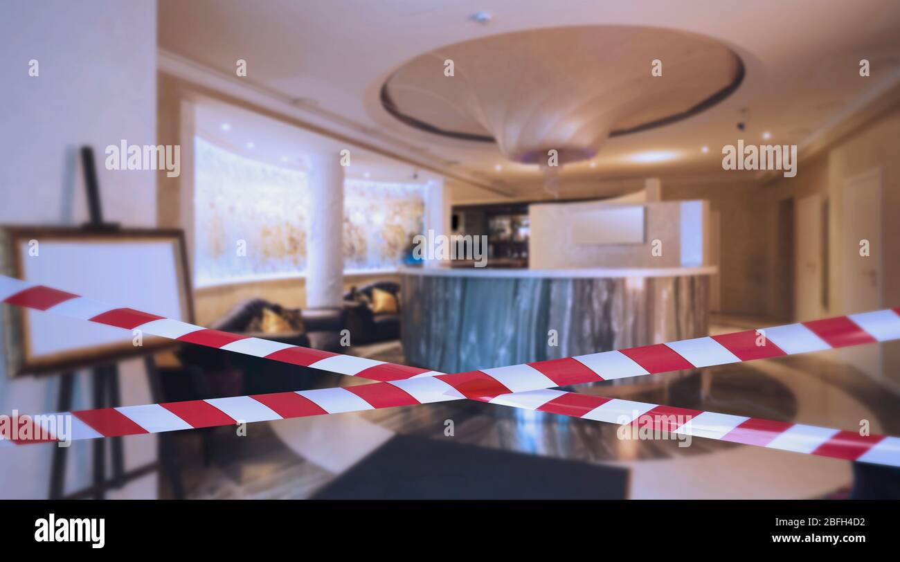 Hazard safety stripes across empty closed luxury hotel lobby Stock ...